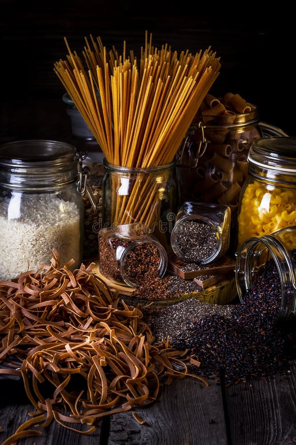 Different Types of Pasta, Rice, Seeds of Flax and Chia on Dark Wooden ...