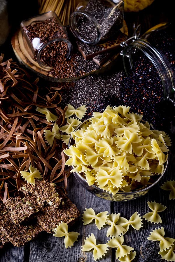 Different Types of Pasta, Rice, Seeds of Flax and Chia on Dark Wooden ...