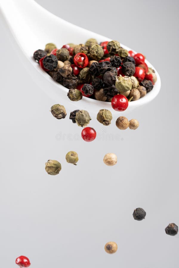 Different Types of Peppercorns Pouring. Red, Green, White and Black ...
