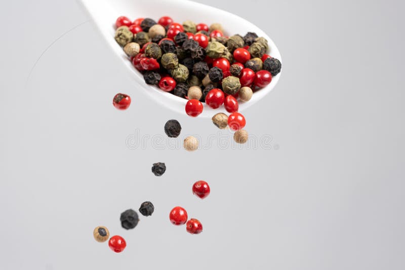 Different Types of Peppercorns Pouring. Red, Green, White and Black ...