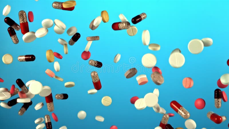 Different Types of Pills Fly Up and Fall Down. Filmed on a High-speed ...