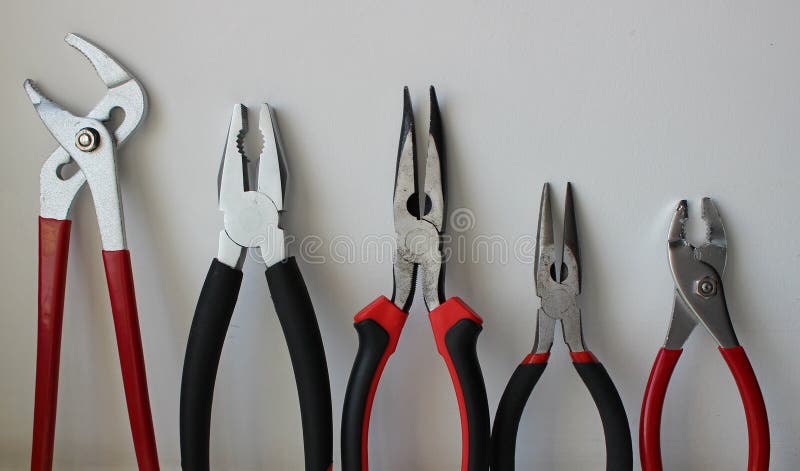 Different Types of Pliers with Plastic Handles Arranged by Size ...