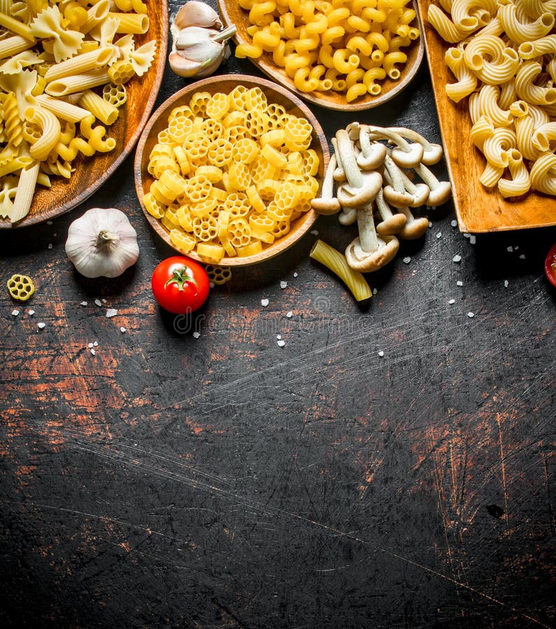 Different Types of Raw Paste on a Plate with Garlic and Mushrooms Stock ...