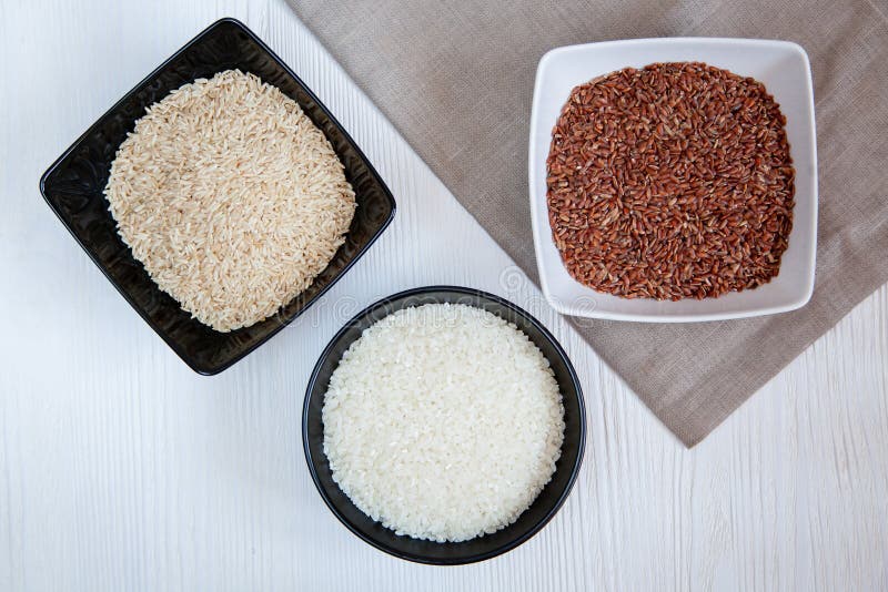 Different Types of Rice in Cups on the Table. White, Brown and Red ...