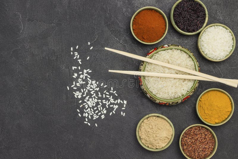 Different Types of Rice and Dry Spices in Bowls. Bamboo Sticks Stock ...