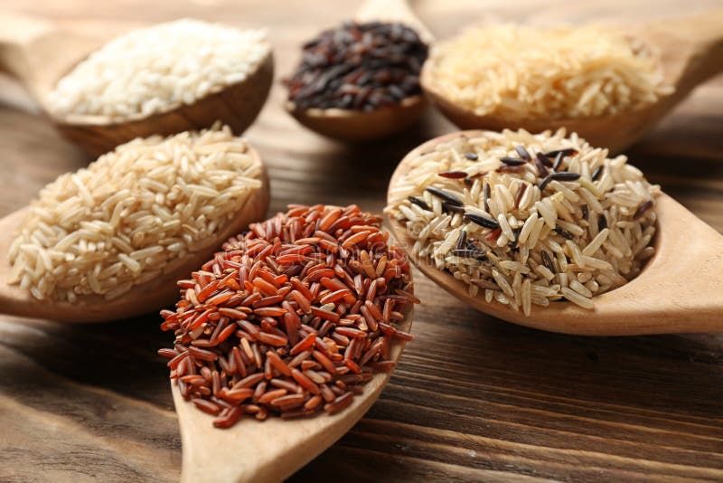 Different Types of Rice in Spoons on Wooden Background Stock Photo ... Different Types of Rice in Spoons on Wooden Background Stock Photo ...
