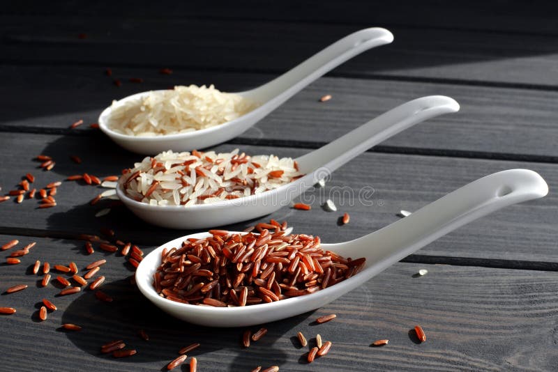 Different Types of Rice in Spoons on Wooden Table Background Stock ... Different Types of Rice in Spoons on Wooden Table Background Stock ...