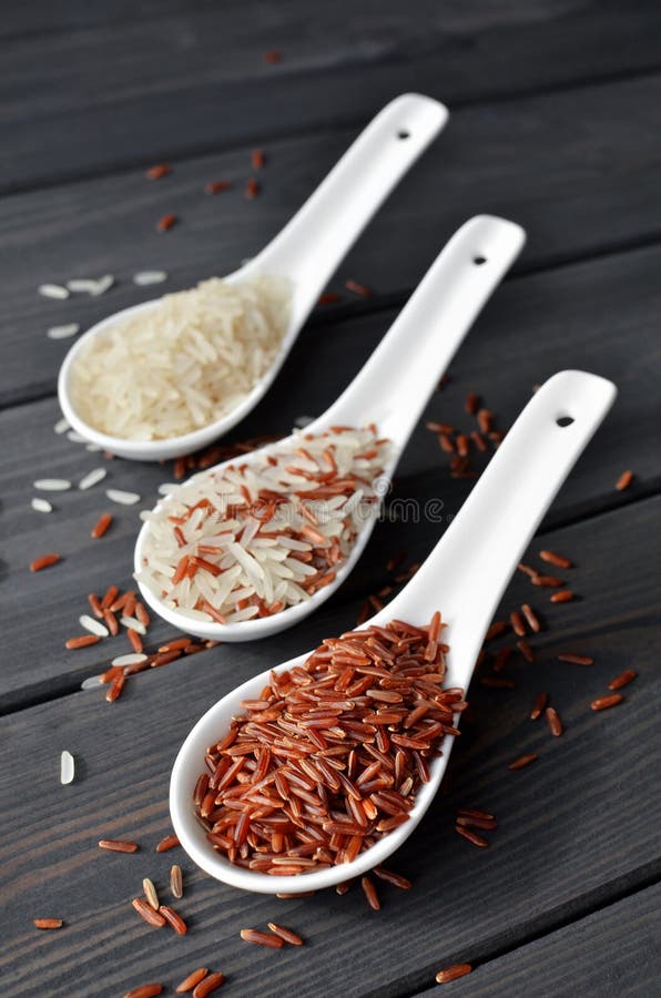 Different Types of Rice in Spoons on Wooden Table Background Stock ... Different Types of Rice in Spoons on Wooden Table Background Stock ...