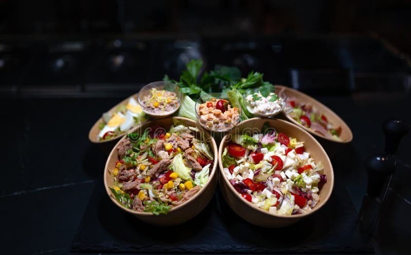 Different Types of Salads in a Bowl on Black Background. Stock Photo ...
