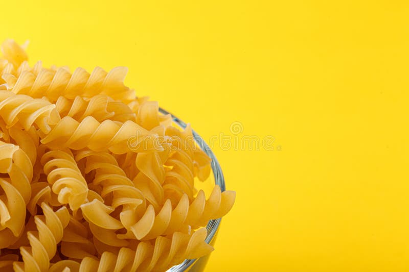 Different Types and Shapes of Dry Italian Pasta on a Yellow Background ...