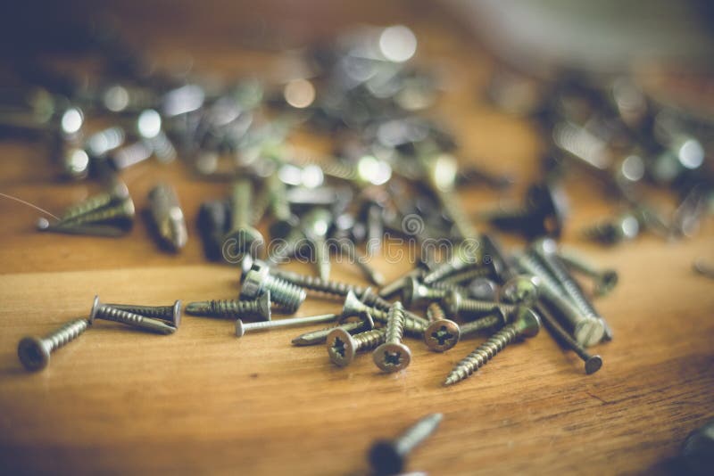 Different Types and Sizes of Nails and Screws on a Wooden Table Stock ...