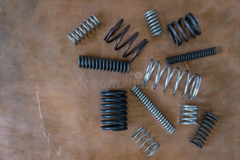 Different Types of Springs or Coil Springs on a Copper Background ... Different Types of Springs or Coil Springs on a Copper Background ...