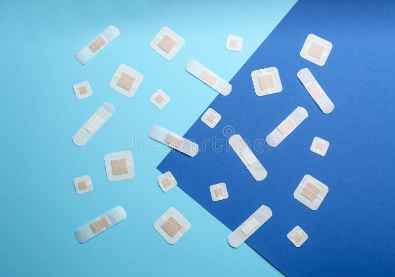 Different Types of Sticking Plasters on Blue Background Stock Photo ...