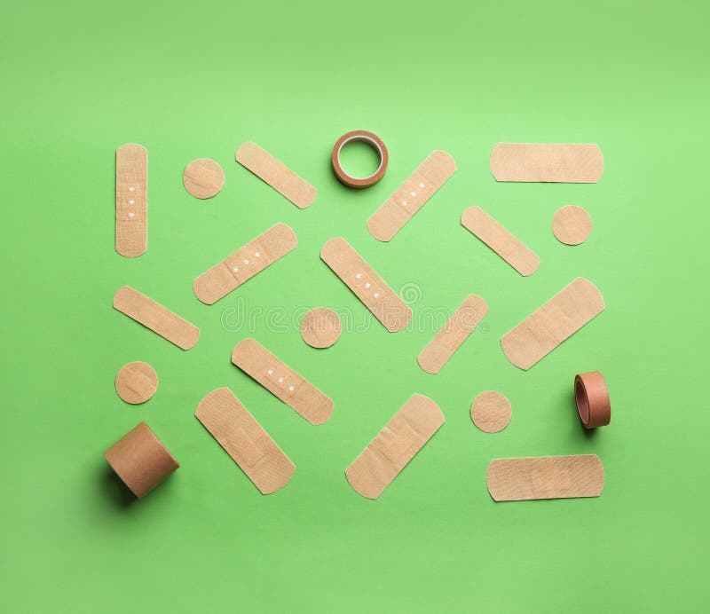 Different Types of Sticking Plasters on Green Background, Flat Lay ...