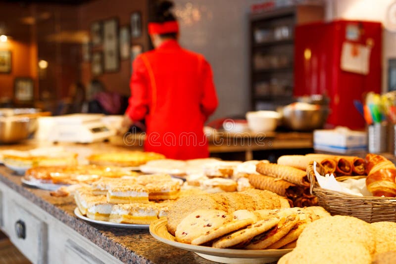 Different Types of Sweet Pastries on Plates at Counter Cafe Stock Photo ...