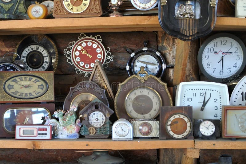Different Types of Watches on the Shelf. an Old Wall Clock. Dusty Dials ...