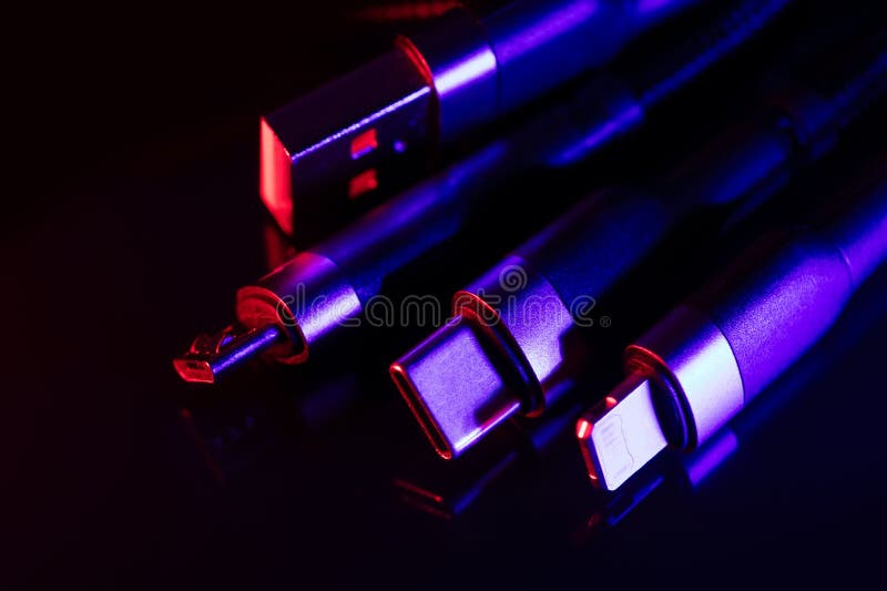 Different USB Charging Plugs on Dark Background. USB Type C, Micro USB ...