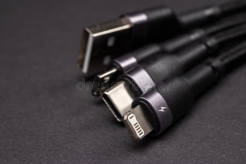 Different USB Charging Plugs on Dark Background. USB Type C, Micro USB ...