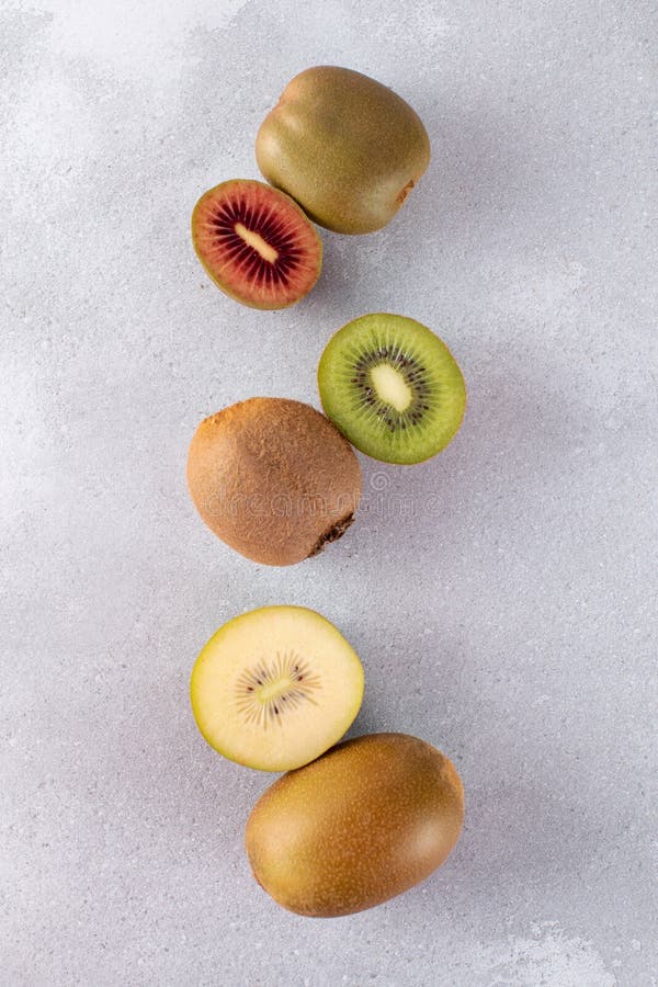 Different Varieties of Kiwi Lie in a Pile on the Table. Halves of Red ... Different Varieties of Kiwi Lie in a Pile on the Table. Halves of Red ...