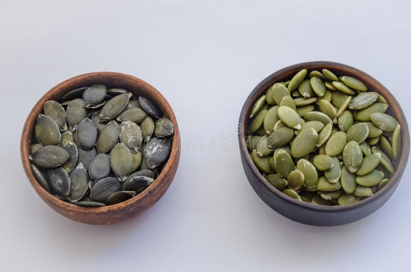 Different Varieties of Pumpkin Seeds in Plates on a Light Background ...