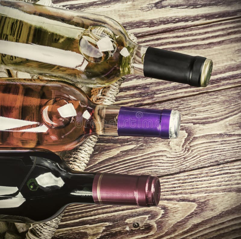 Different Varieties of Wine Bottles in a Basket on the Table. Stock ...