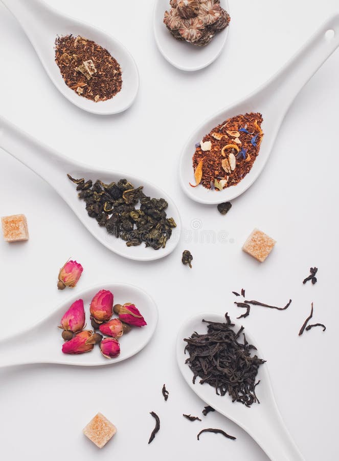 Different Variety of Dry Tea in White Spoons on the White Background ...