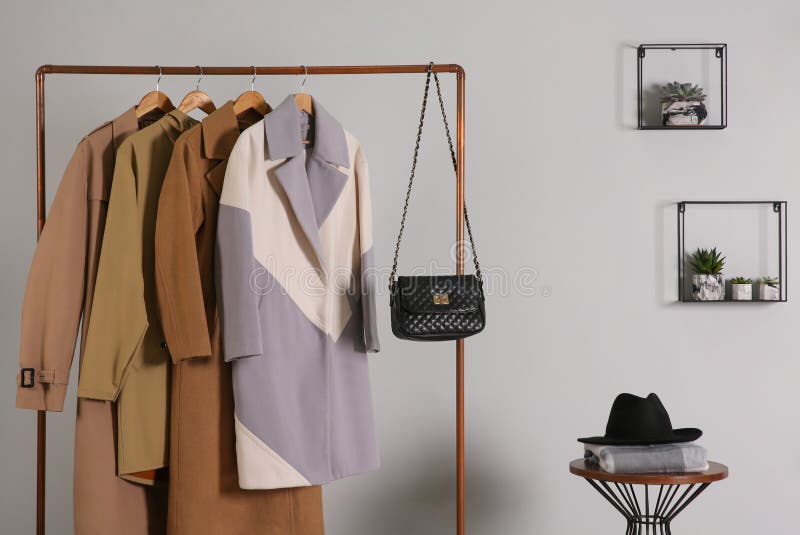 Different Warm Coats on Rack in Stylish Room Interior Stock Image ...