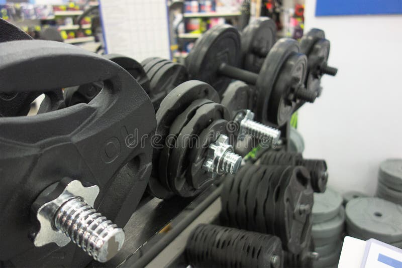 Different Weights from the Bar and Dumbbells in the Sports Store ...