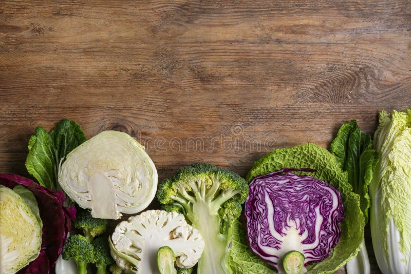 Different Whole and Cut Types of Cabbage on Wooden Table, Flat Lay ...