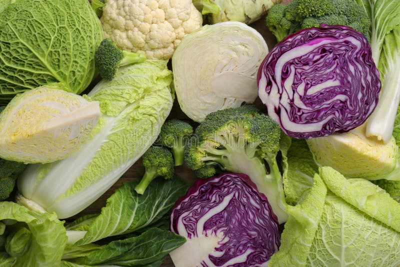 Different Whole and Sliced Types of Cabbage As Background, Top View ...