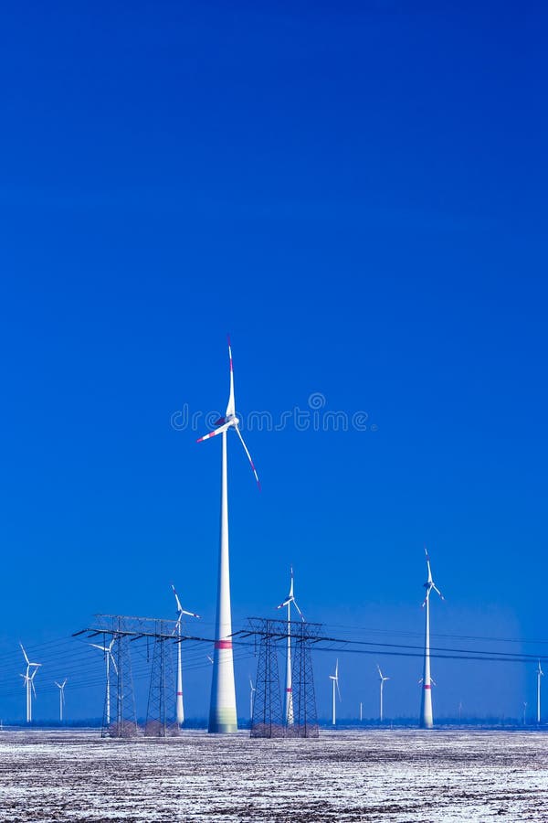 Different Windmills with Transmission Line in Winter Landscape Stock ...