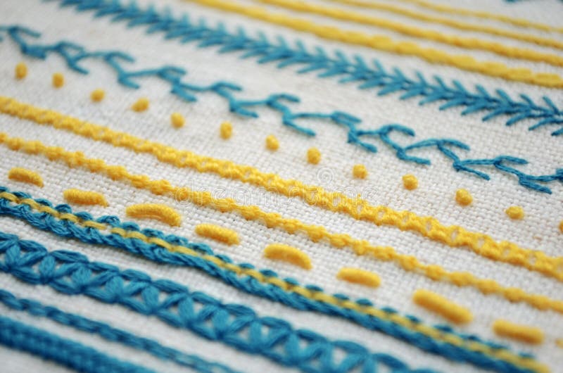 Different Yellow and Blue Patterns of Embroidery on White Fabric Stock ...