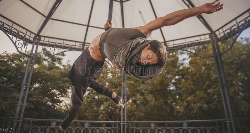 Difficult Training of Young Athlete on Strings Above Dome of Light ...