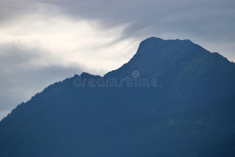 Diffused Sunlight and Mountain Peak Stock Image - Image of brushed ...