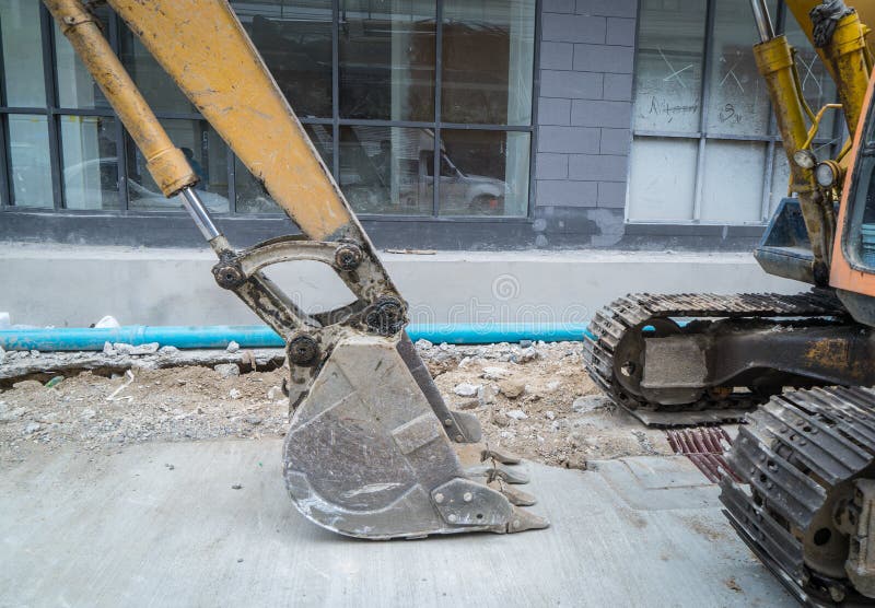 Digger on a Construction Site Stock Image - Image of tubes, sand: 74248231