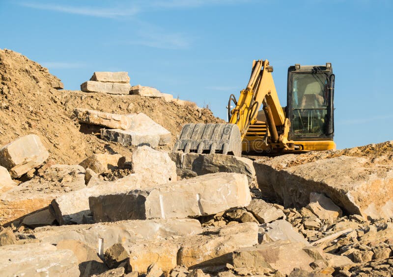 Digger on a Construction Site Building a Stone Wall Stock Photo - Image ...