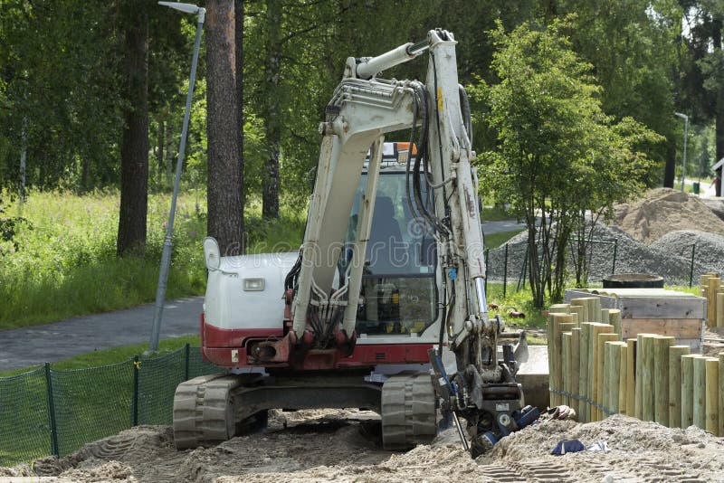 Digger on a Construction Site Stock Image - Image of tubes, sand: 74248231