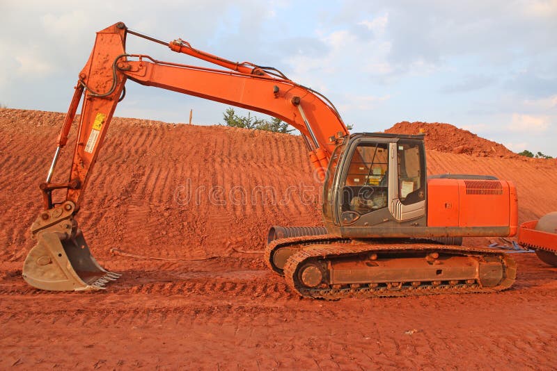 Digger on a Construction Site Stock Photo - Image of tracks, gravel ...