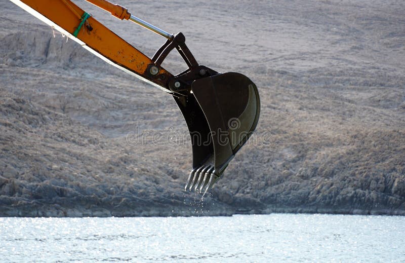 A Digger Crane Digs the Seabed and Grabs Rocks from the Seabed Stock ...