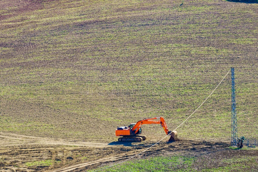Digger excavator on field stock image. Image of construction - 313469193