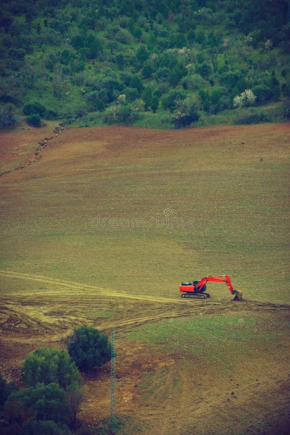 Digger excavator on field stock photo. Image of construction - 336470836