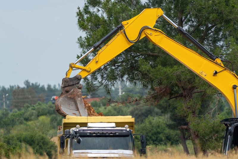 Digger Loading Soil Onto a Truck Stock Image - Image of earthmover ...