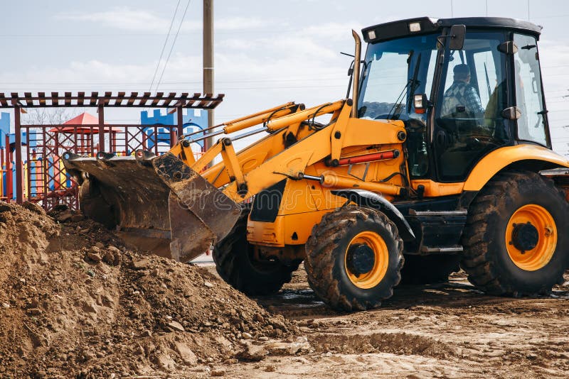 Digger Machine Digging and Removing Earth in Construction Site Stock ...