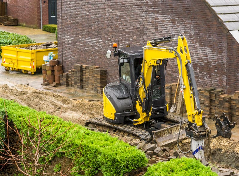 Digger Machine Working on a Garden Construction in a Modern ...