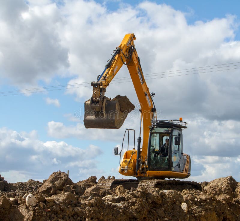 A Digger Tipping Soil into a Site Dumper Truck Editorial Stock Photo ...