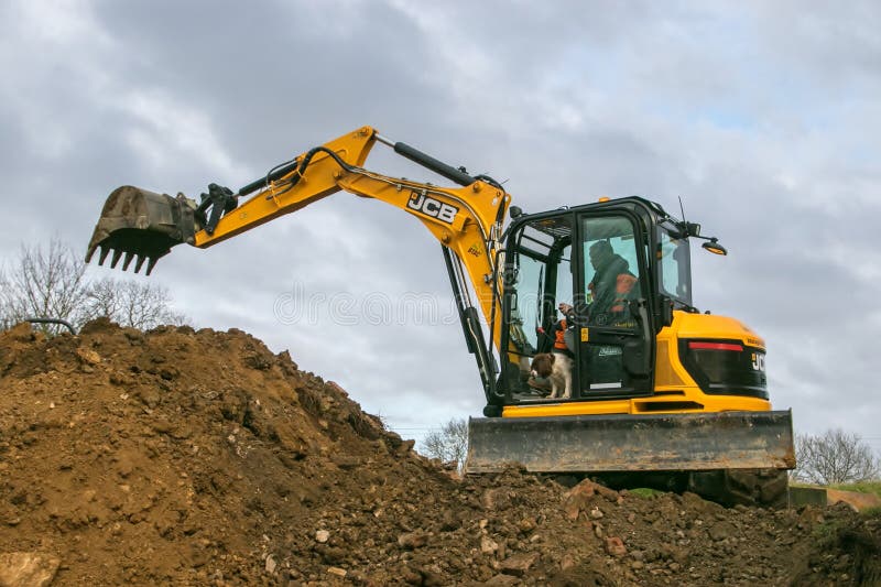 A Digger Tipping Soil into a Site Dumper Truck Editorial Stock Photo ...