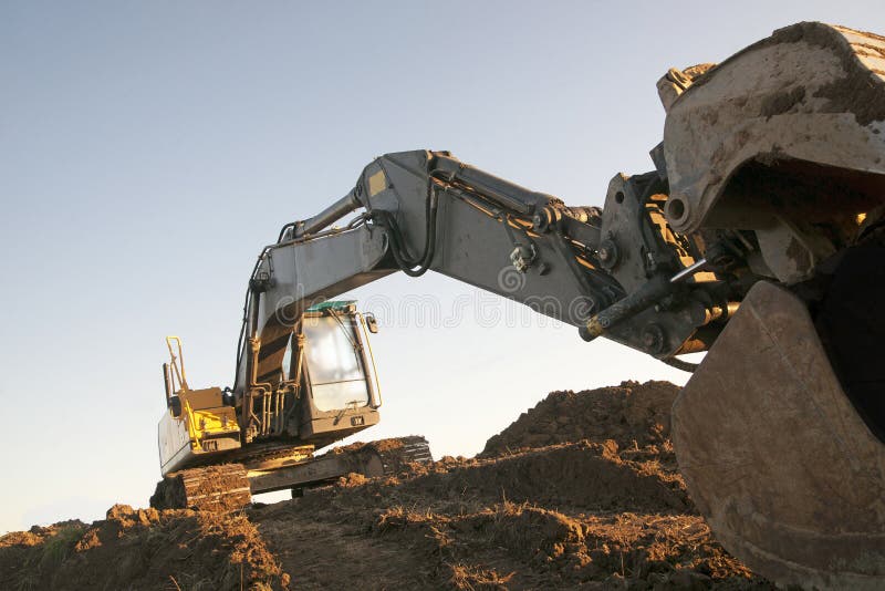 Digger at sunset stock image. Image of machine, industry - 21932161