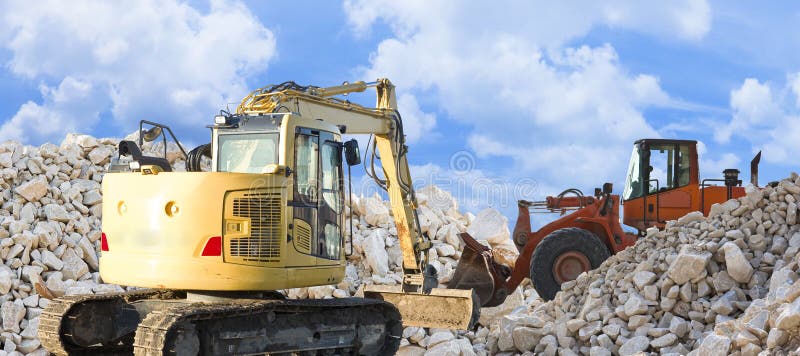 Diggers Building a Dam of White Stones on a Construction Site Stock ...