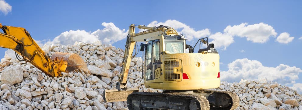 Diggers Building a Dam of White Stones on a Construction Site Stock ...