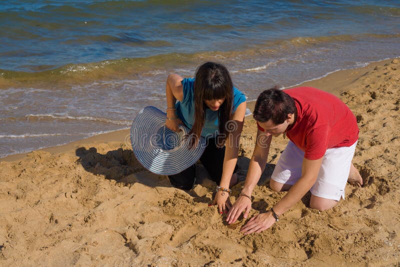 Digging on the beach stock image. Image of togetherness - 40651809
